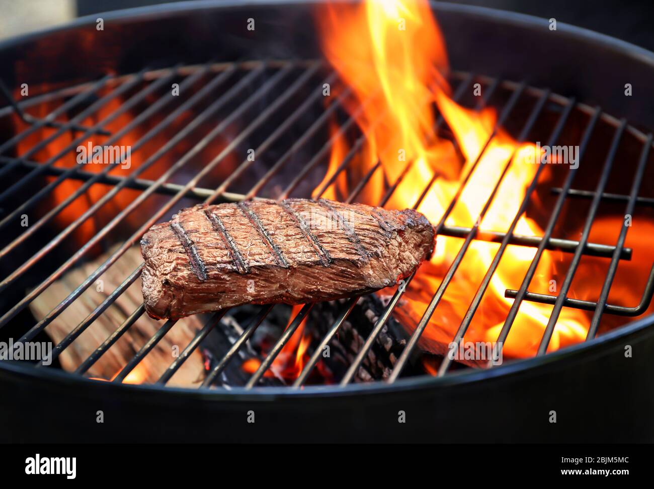 Delicious cooked meat on grill Stock Photo - Alamy