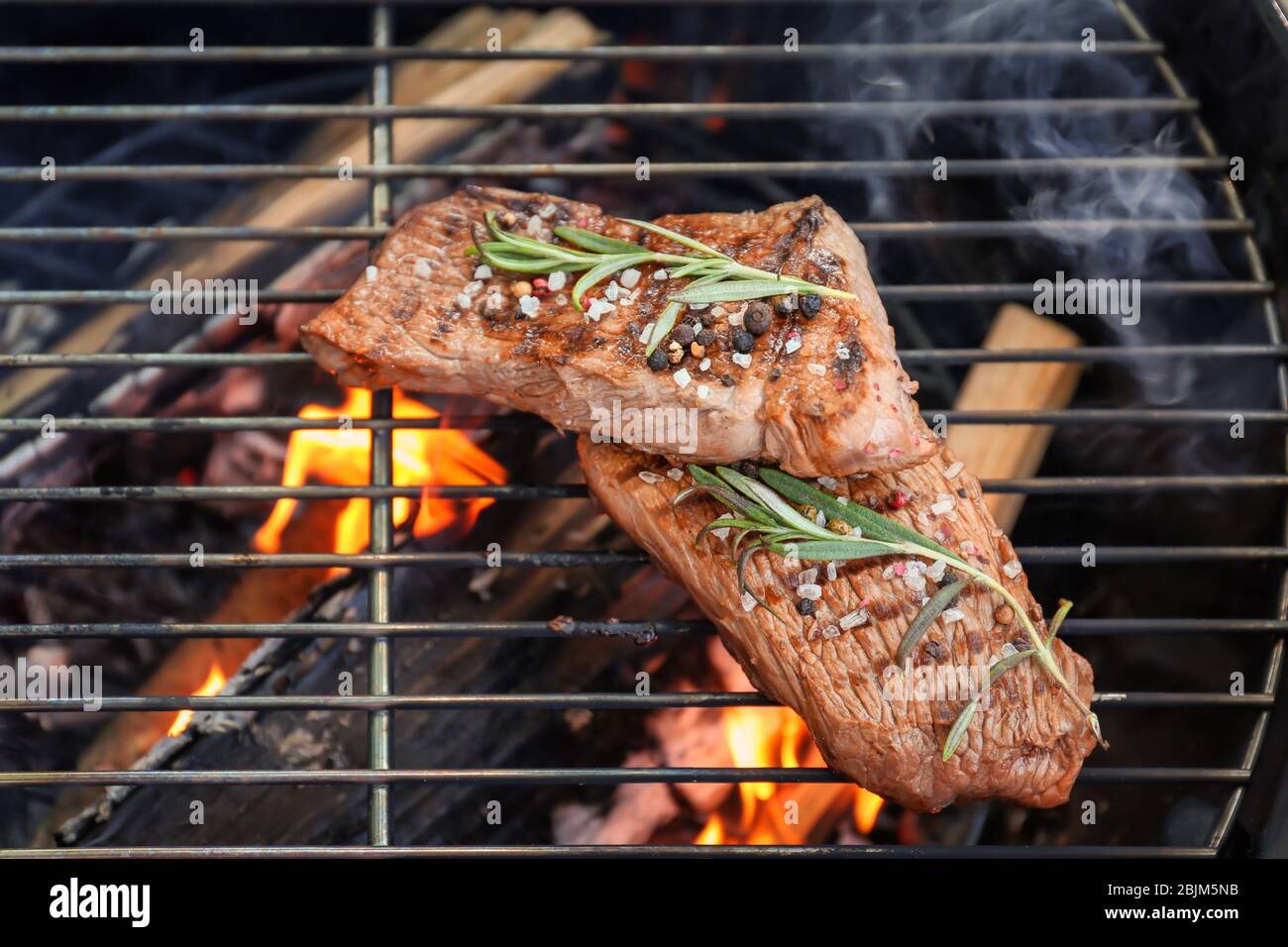 Delicious cooked meat on grill Stock Photo - Alamy