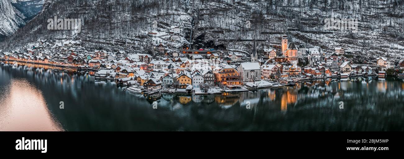 Aerial panoramic drone shot of Hallstatt village covered by snow Stock ...