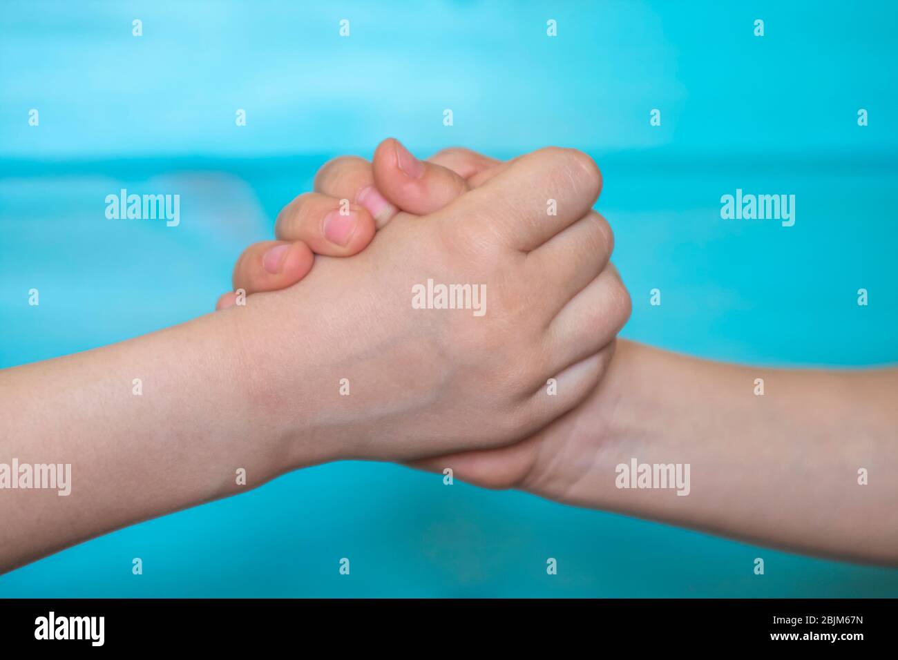 Strong handshake of children as a symbol of friendship Stock Photo - Alamy