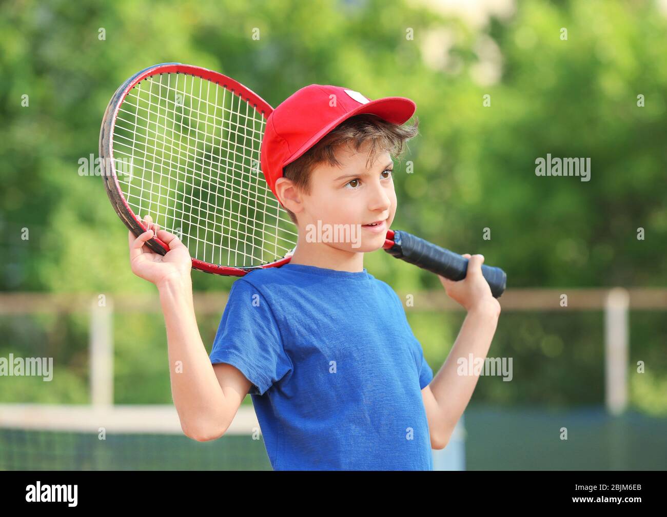 Cute little boy with tennis racket on court Stock Photo - Alamy