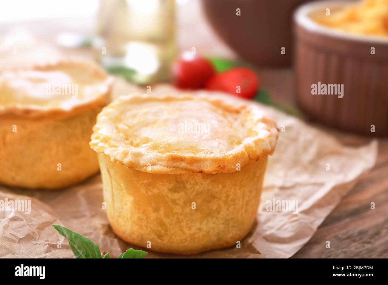 Delicious meat mini pies on parchment, closeup Stock Photo - Alamy