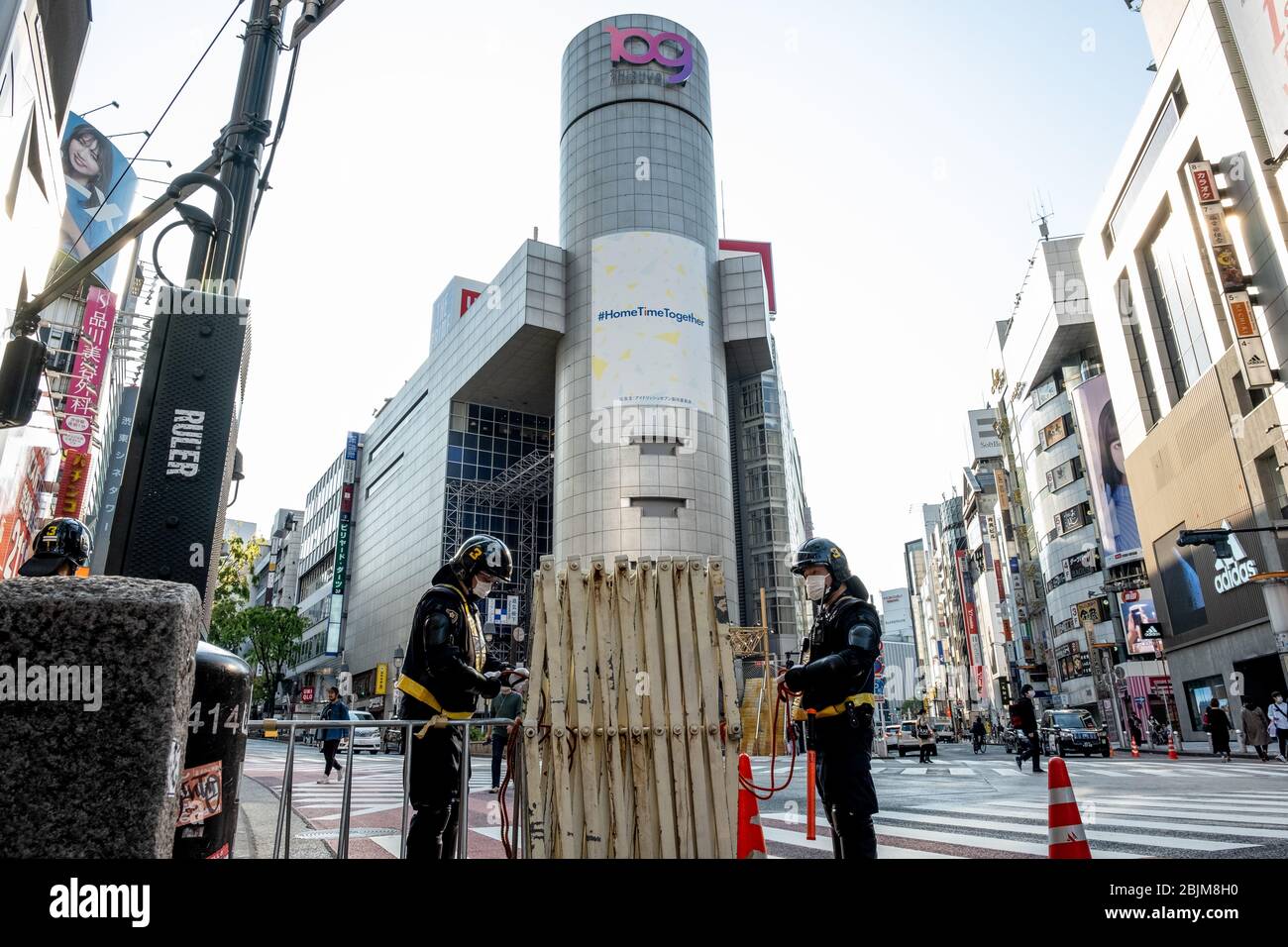 Policemen stand alert along the streets while wearing face masks as a ...