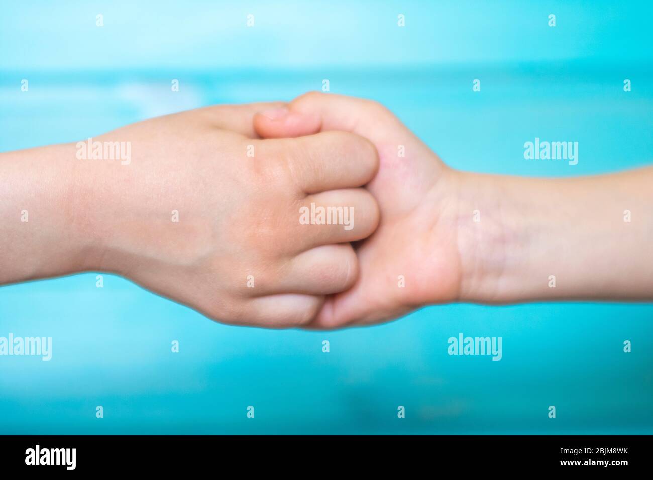 Strong handshake of children as a symbol of friendship Stock Photo - Alamy
