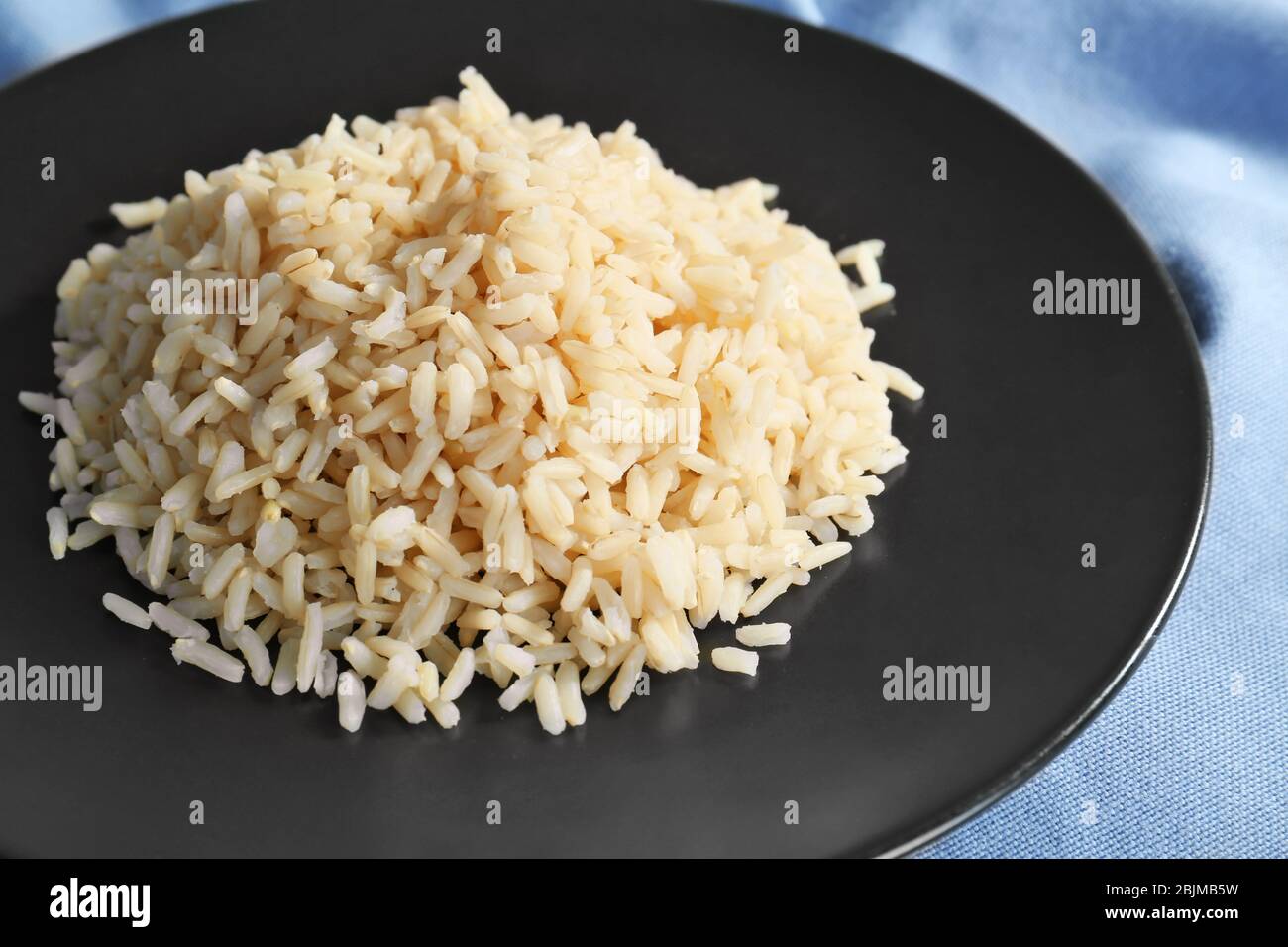 Plate with cooked rice on table Stock Photo - Alamy