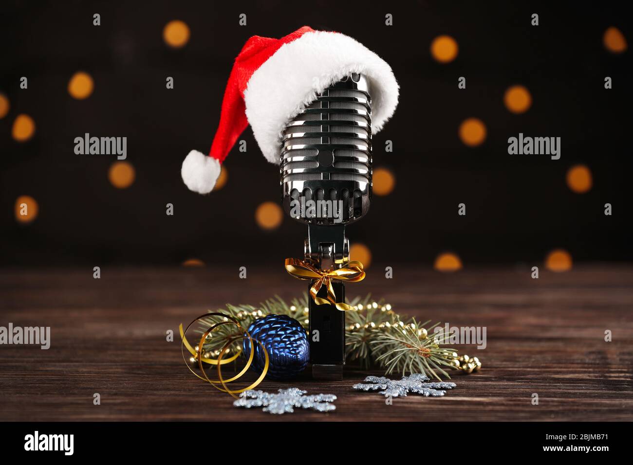 Christmas music concept. Microphone with hat and decoration on wooden ...
