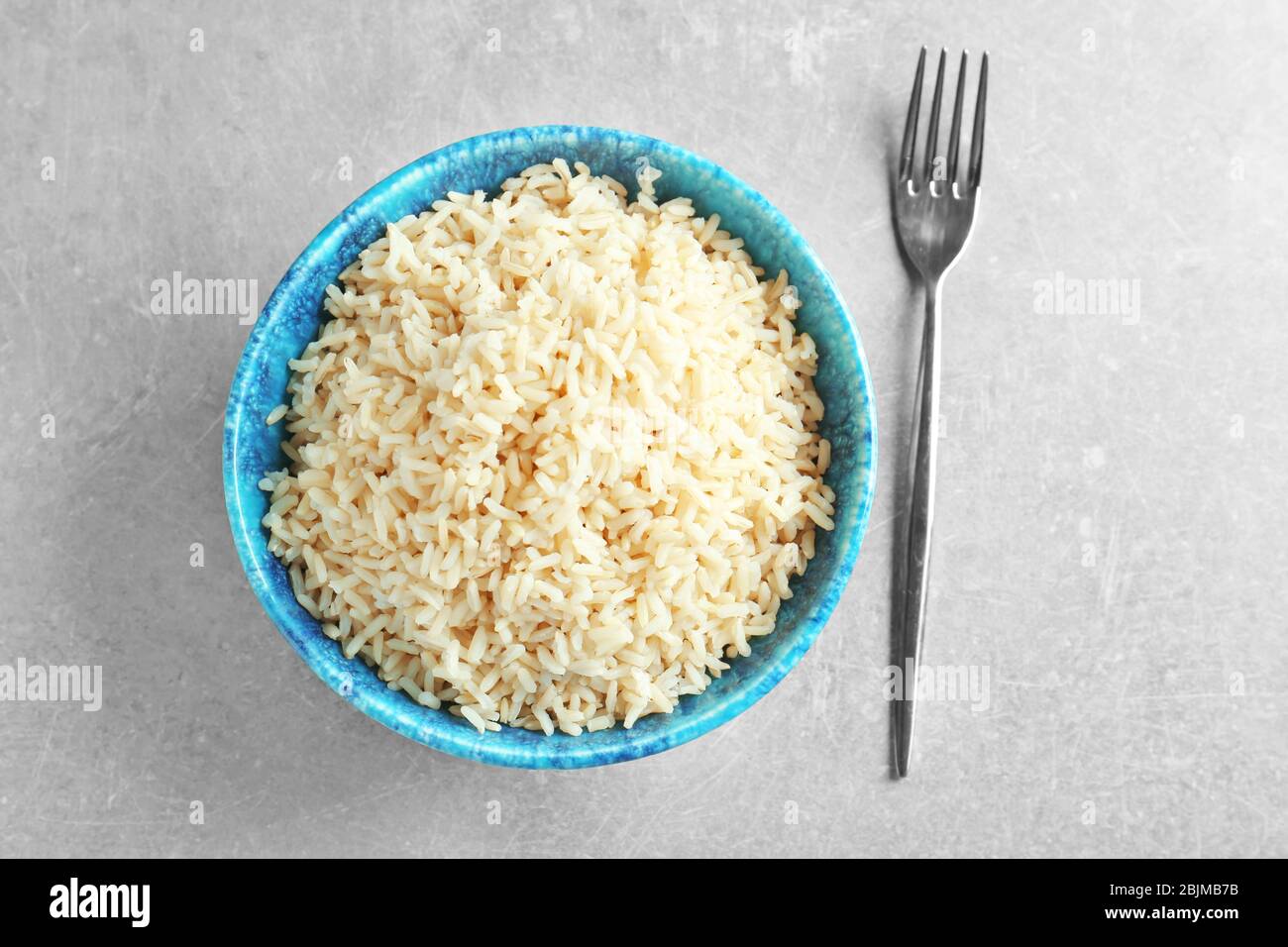 Dish with cooked rice on table Stock Photo - Alamy