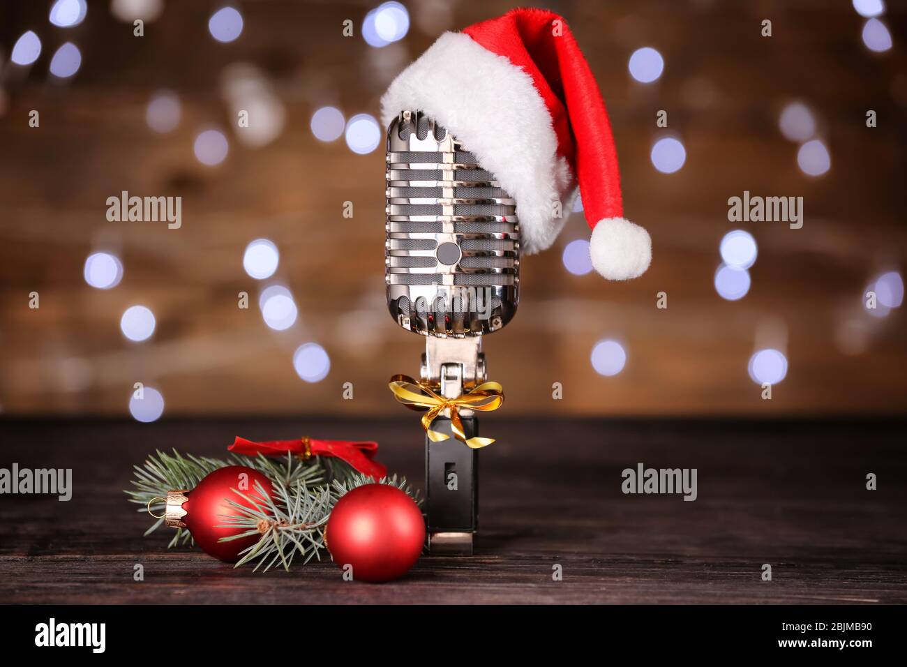 Christmas music concept. Microphone with hat and decoration on wooden ...