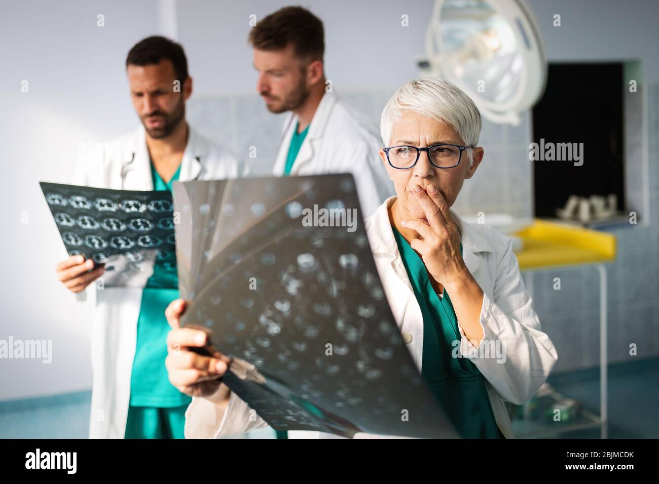 Medical team doctors checking on X-ray results in hospital Stock Photo ...