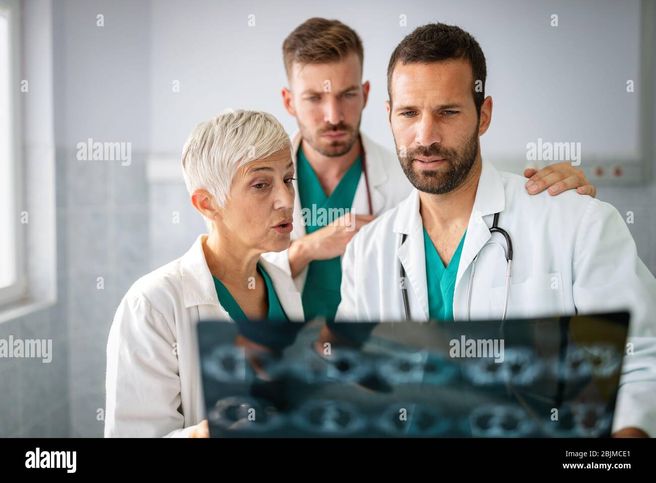 Medical team doctors checking on X-ray results in hospital Stock Photo ...