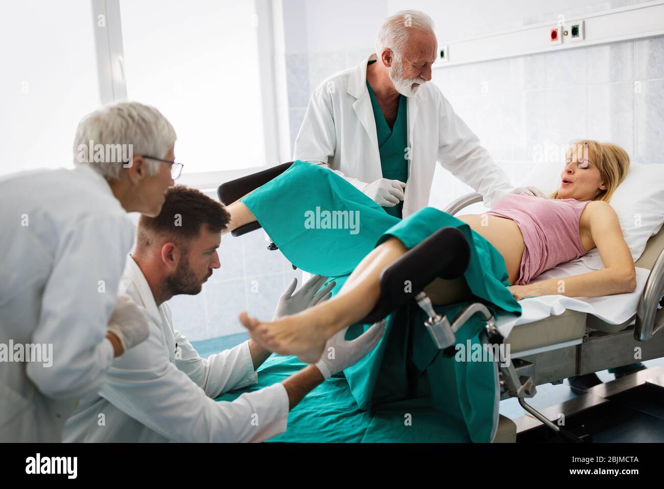 In The Hospital Woman In Labor Pushes To Give Birth Obstetricians
