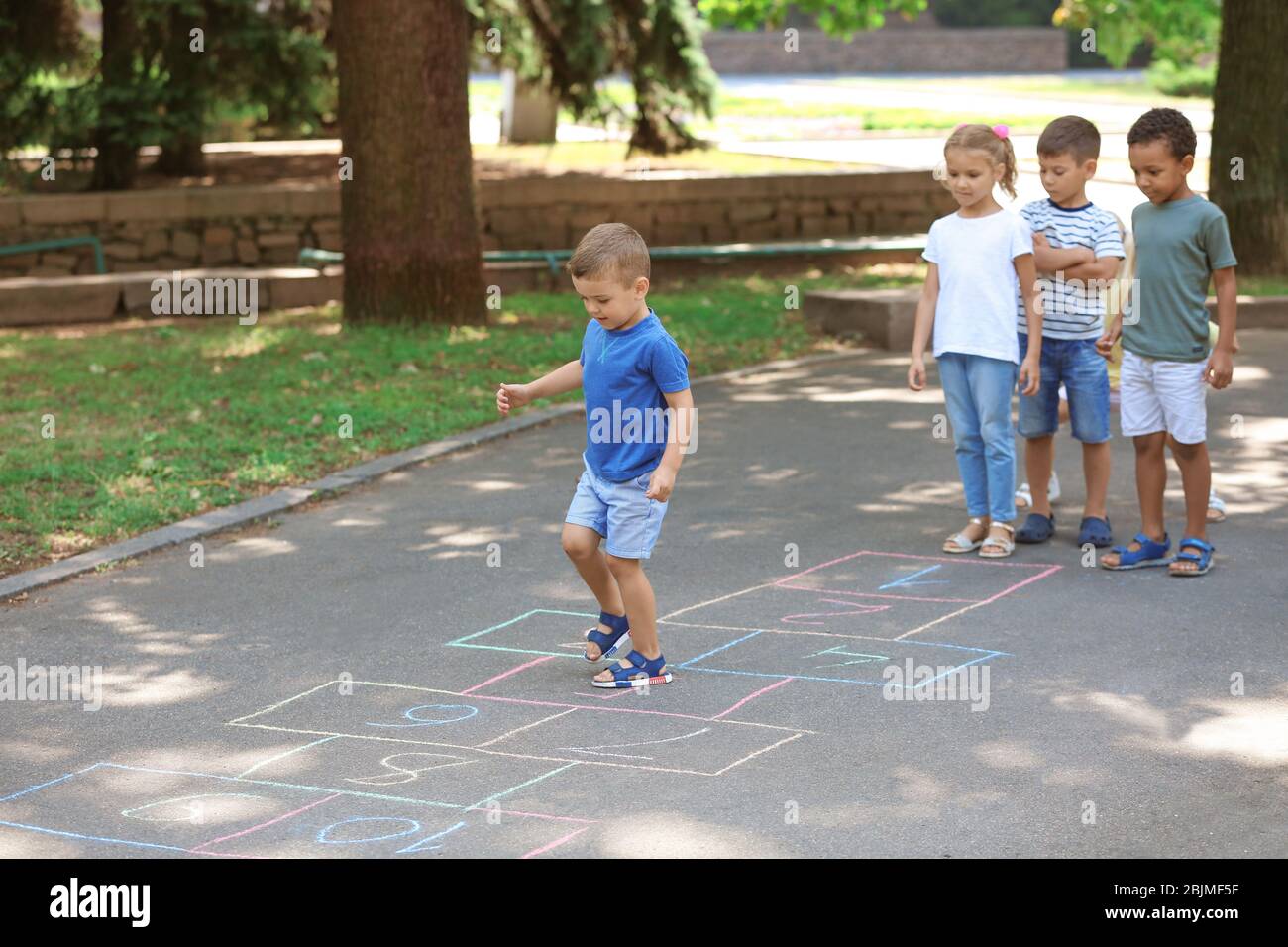 Little children playing hopscotch, outdoors Stock Photo - Alamy