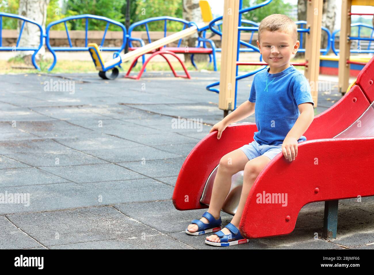 Cute little boy on playground Stock Photo - Alamy