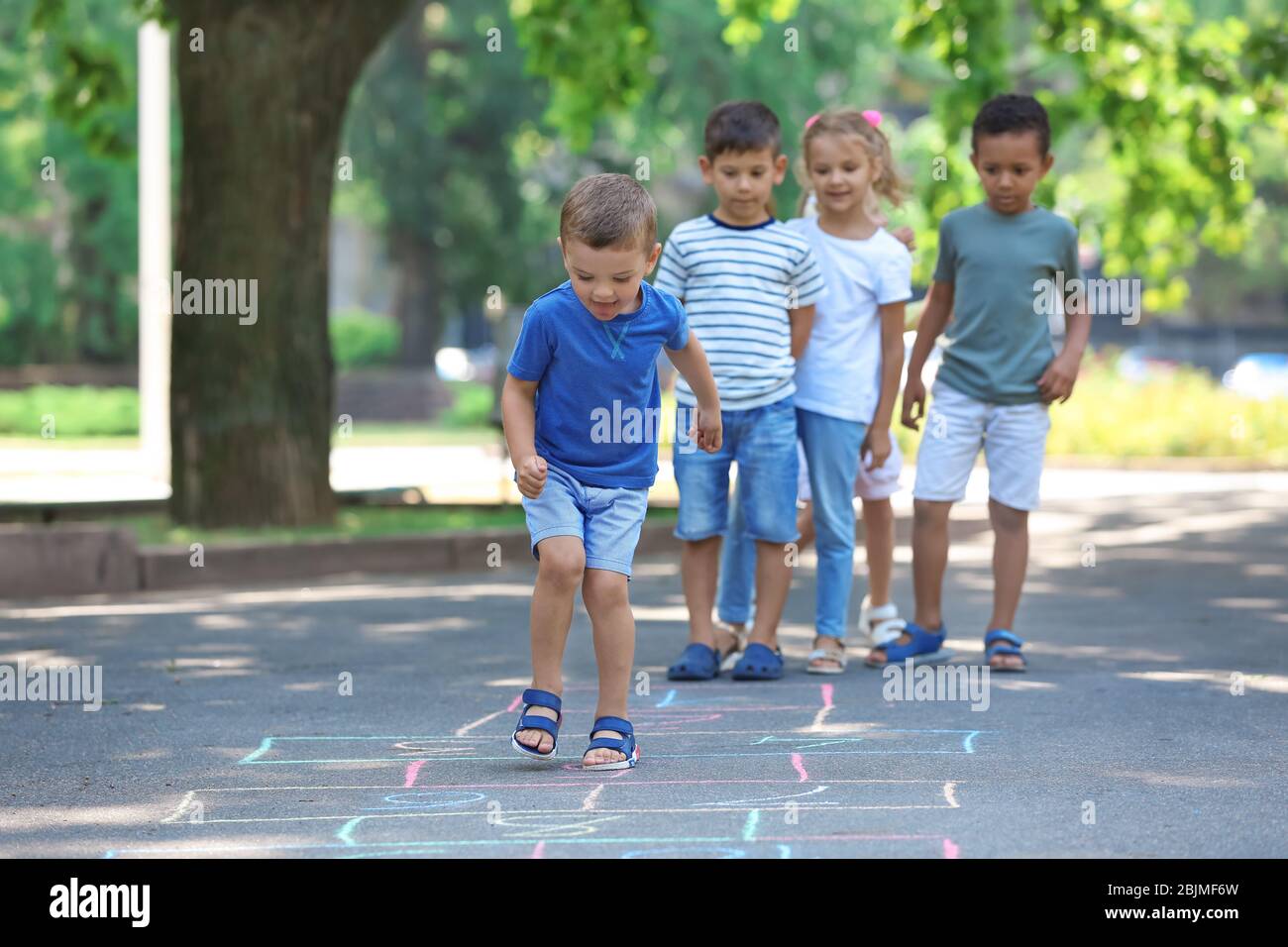 Little children playing hopscotch, outdoors Stock Photo - Alamy