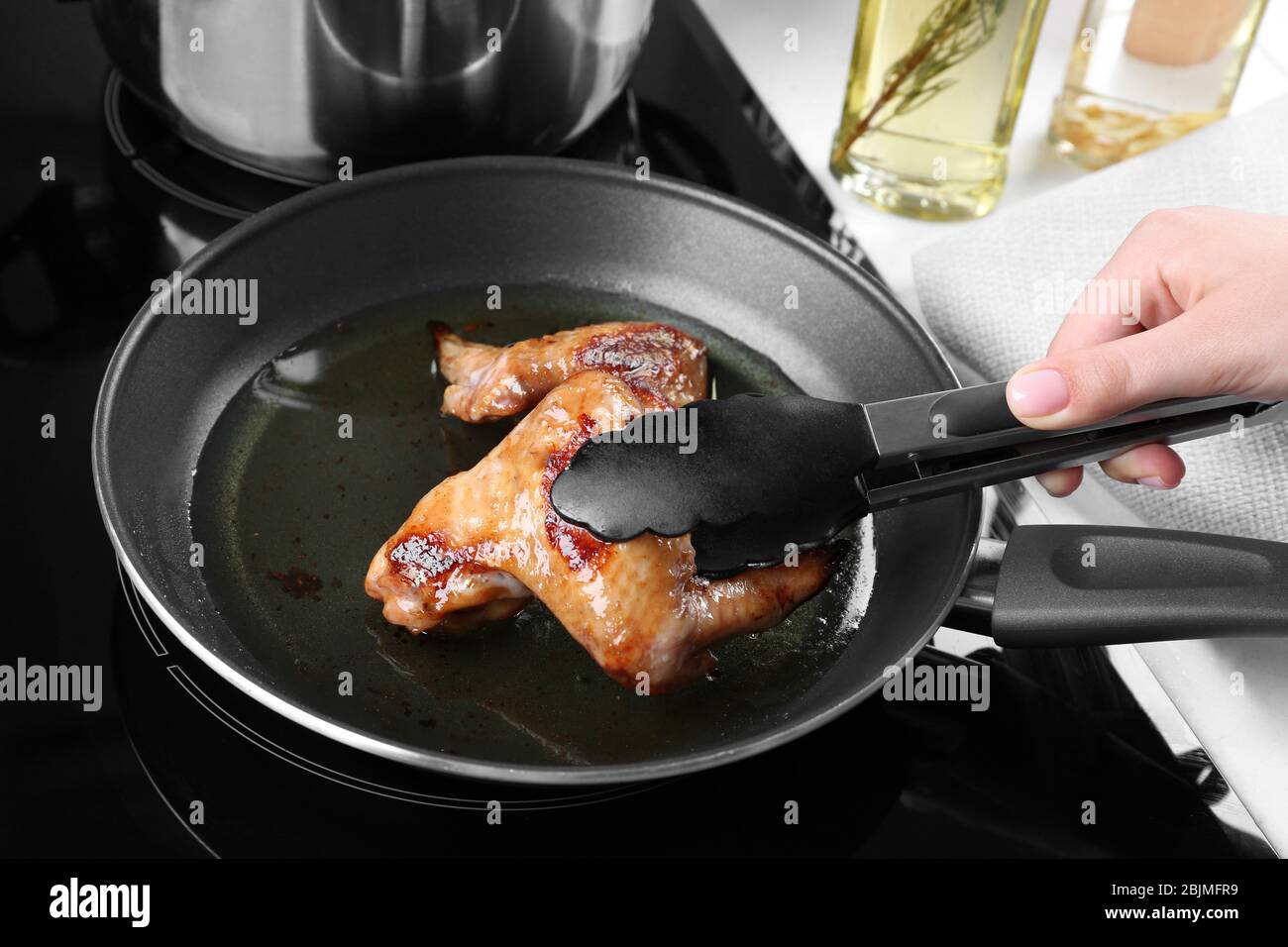 Woman frying chicken hi-res stock photography and images - Alamy