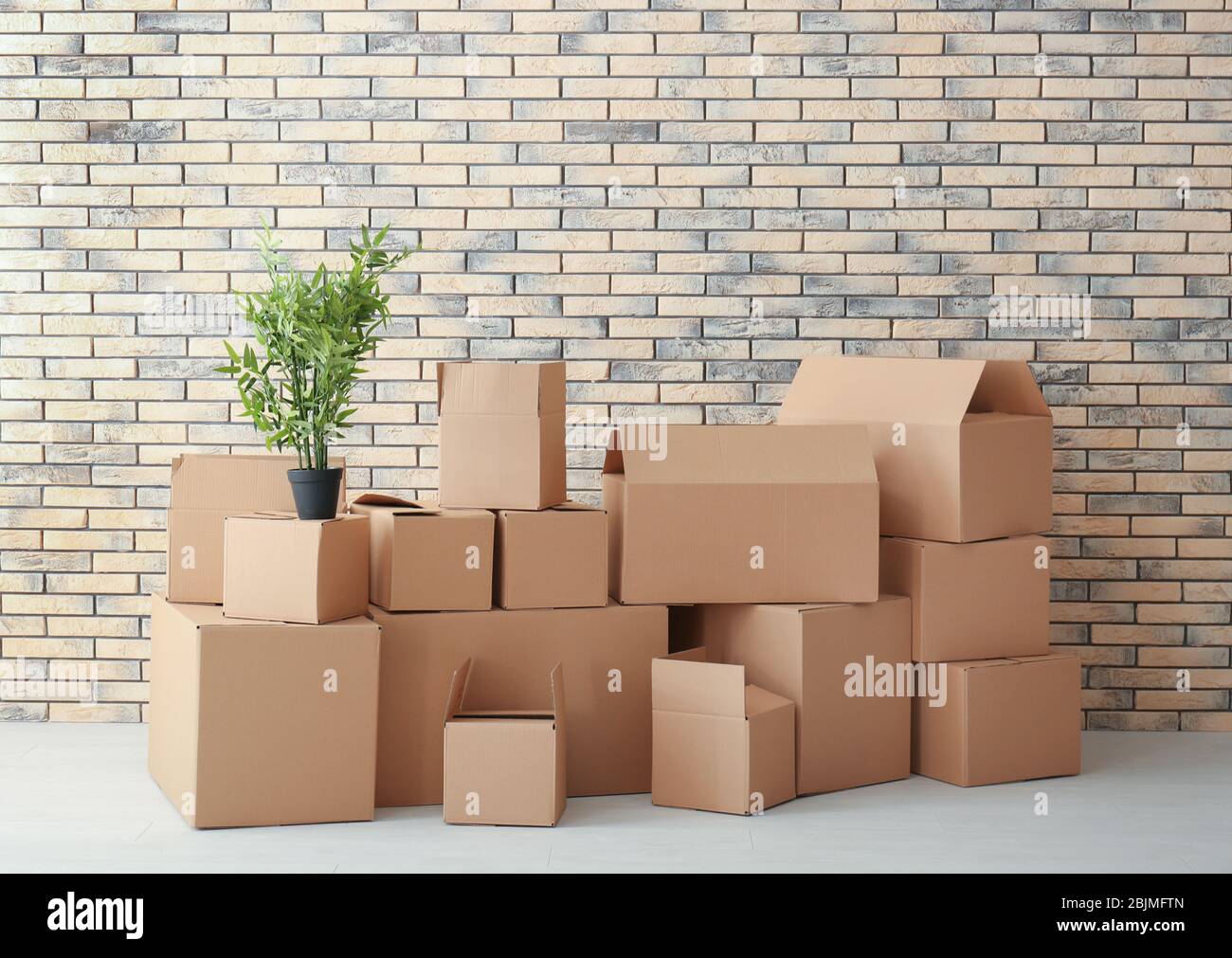 Move house concept. Carton boxes on floor in empty room Stock Photo - Alamy