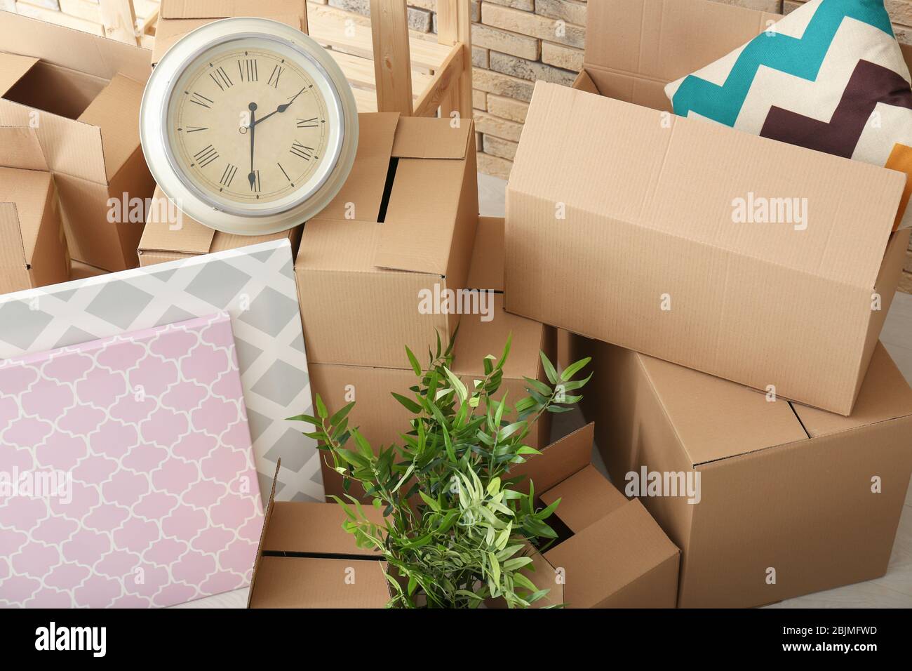 Move house concept. Carton boxes and belongings on floor in room Stock ...