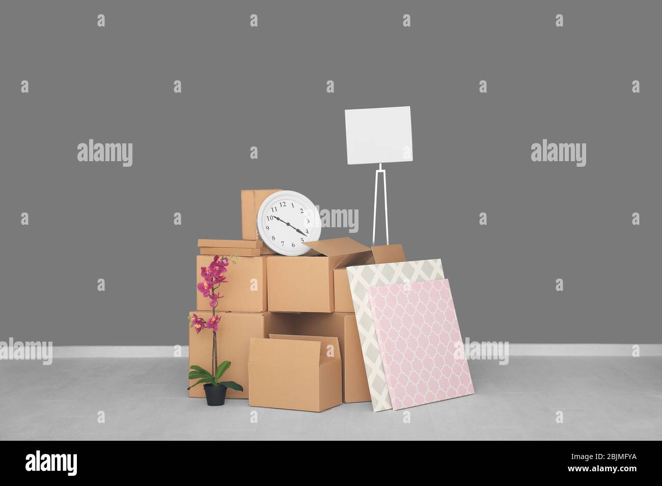 Move house concept. Carton boxes and belongings on floor in empty room ...