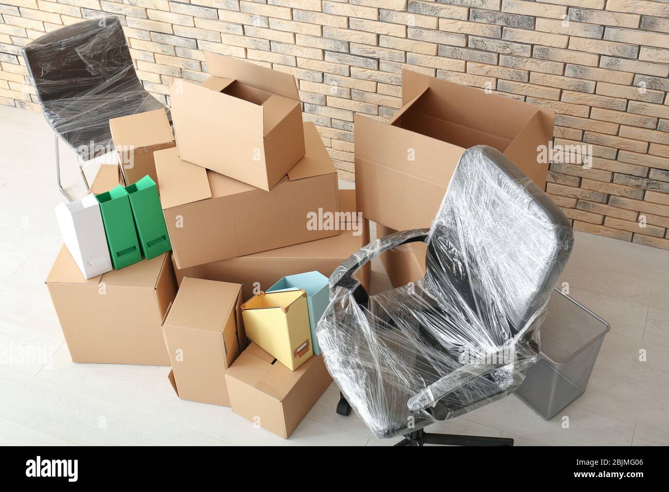 Office move concept. Carton boxes and chairs on floor in empty room ...