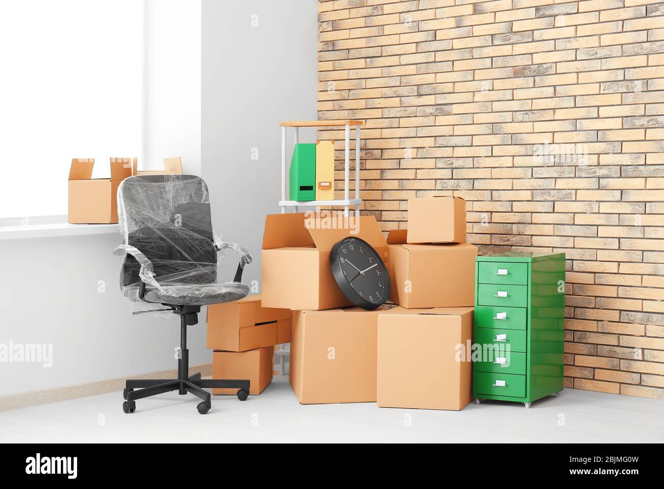 Office move concept. Carton boxes and furniture in empty room Stock ...