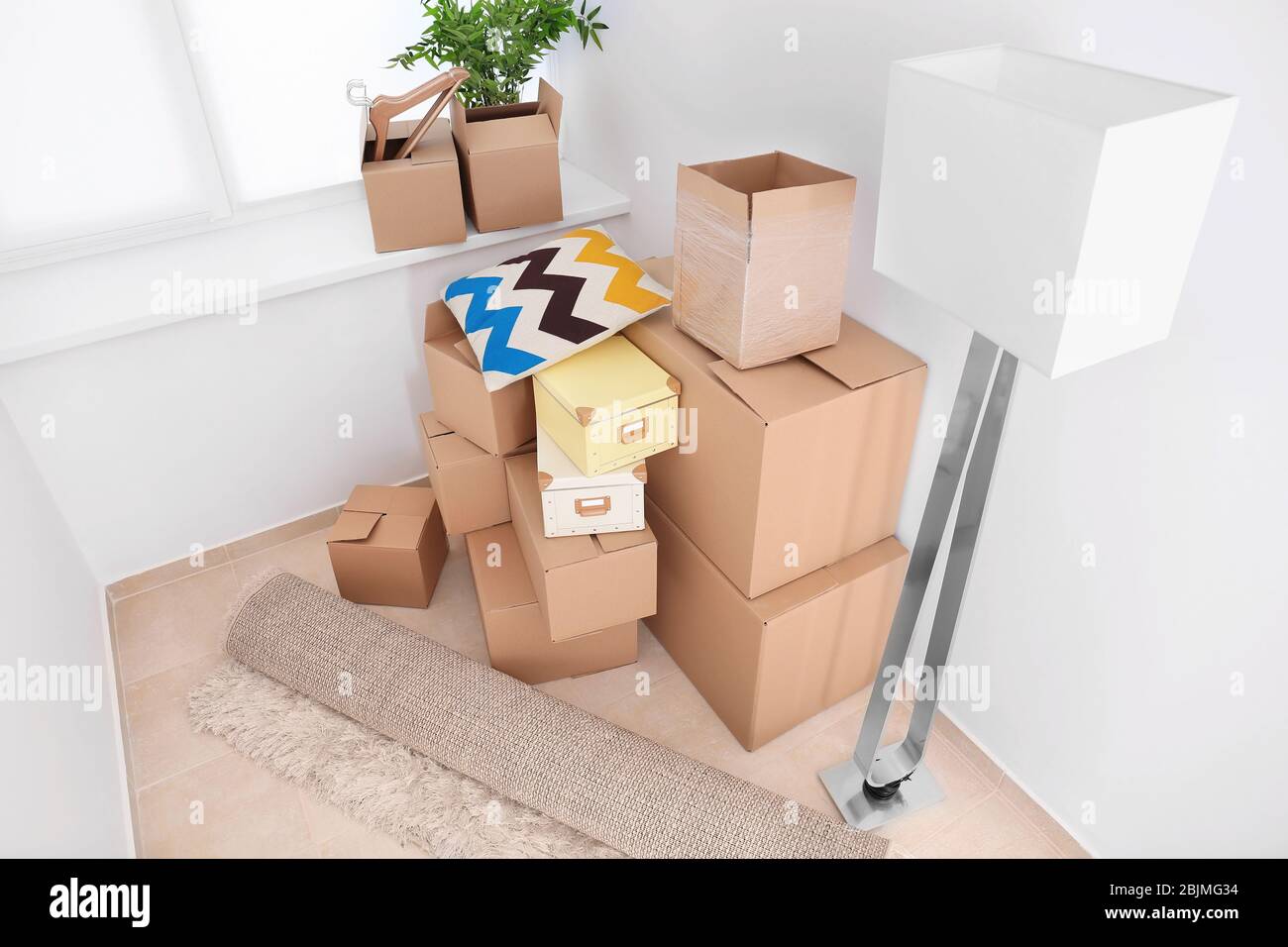 Move house concept. Carton boxes and belongings in empty room Stock ...