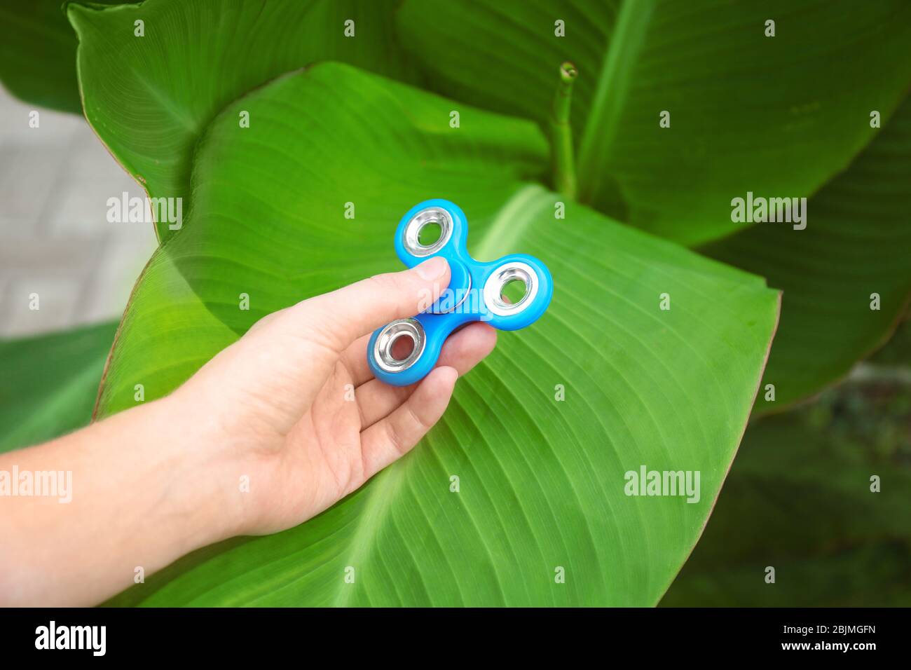 Hand of woman rolling spinner outdoors Stock Photo - Alamy