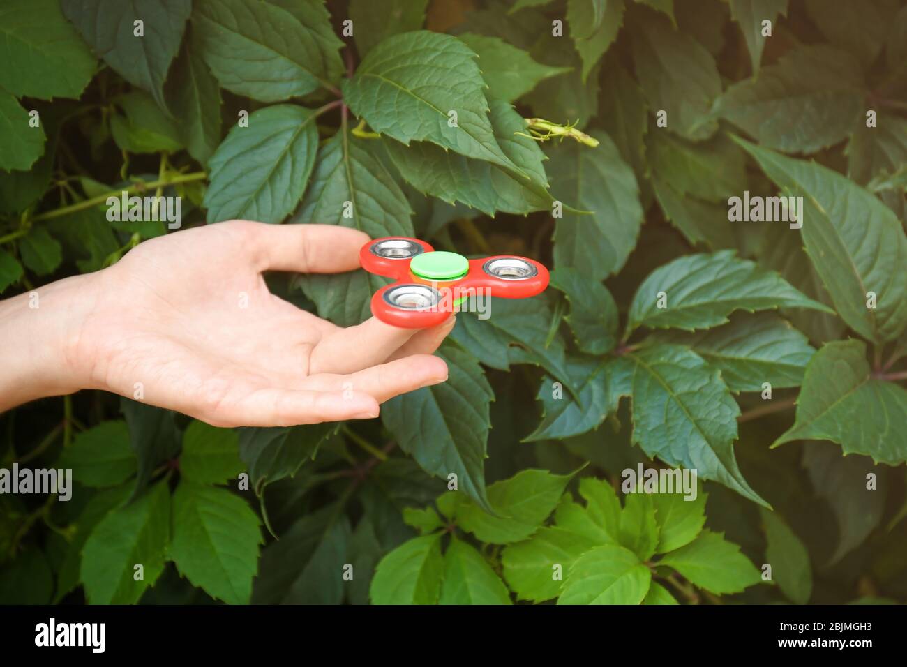 Hand of woman rolling spinner outdoors Stock Photo - Alamy