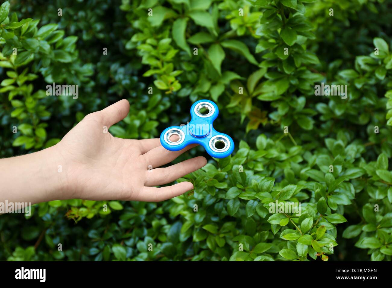 Hand of woman rolling spinner outdoors Stock Photo - Alamy