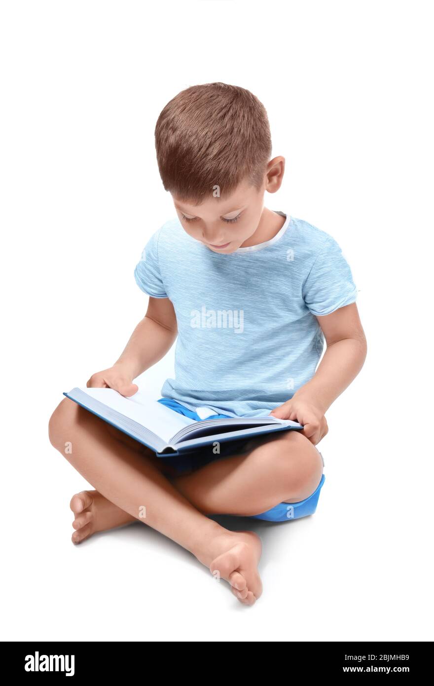 Cute little boy reading book on white background Stock Photo - Alamy