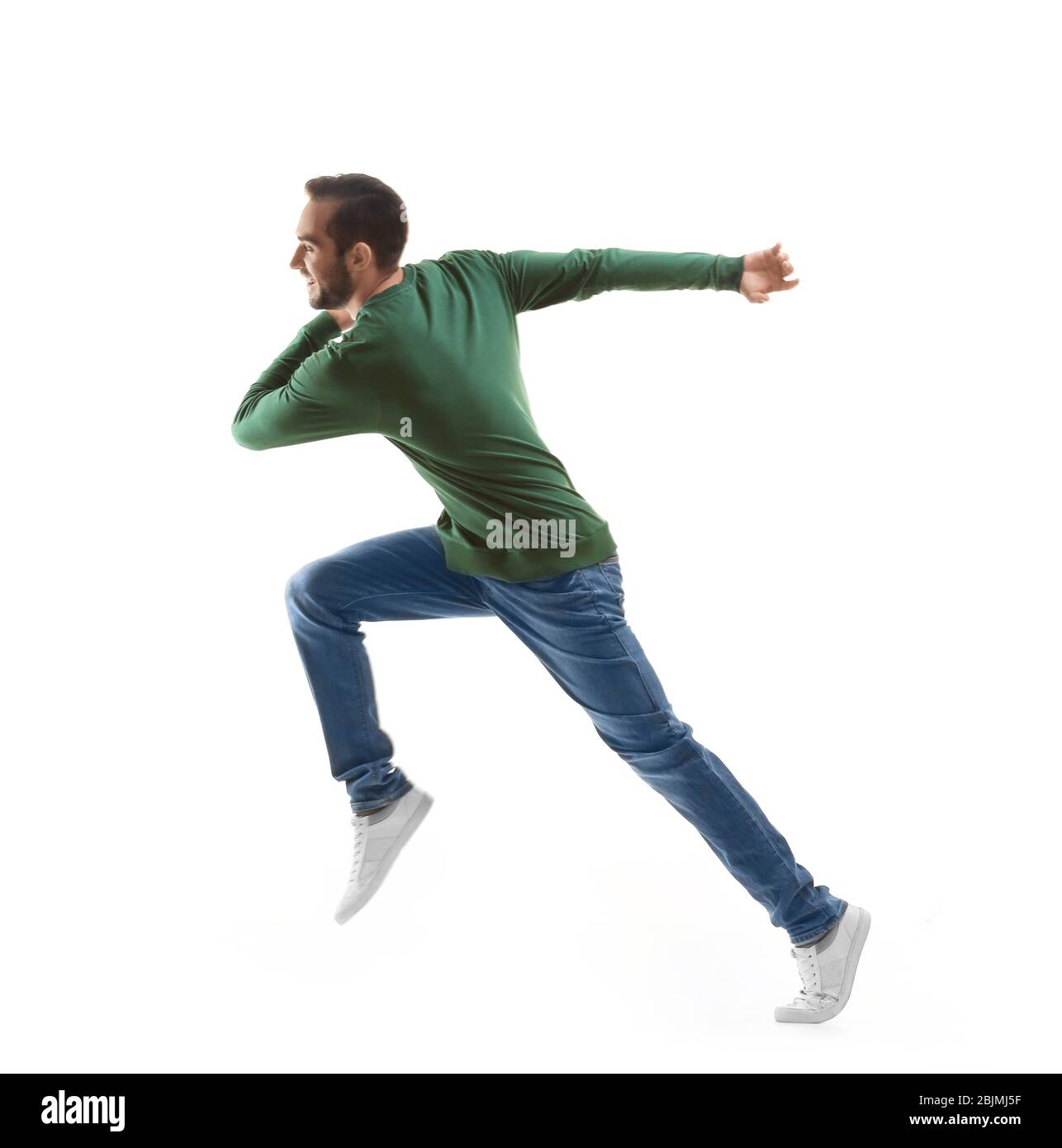 Young man in casual clothes running on white background Stock Photo - Alamy