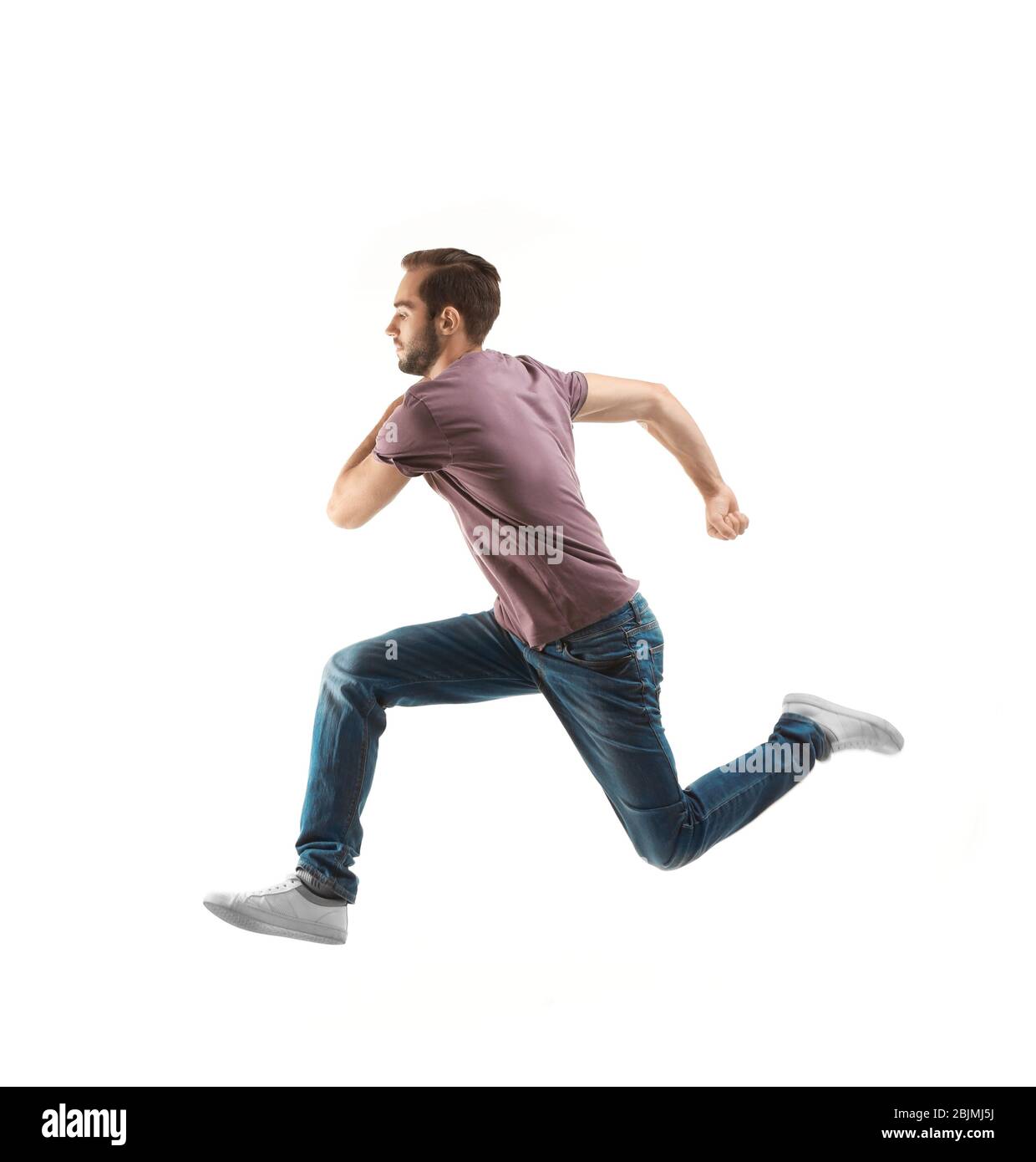 Young man in casual clothes running on white background Stock Photo - Alamy