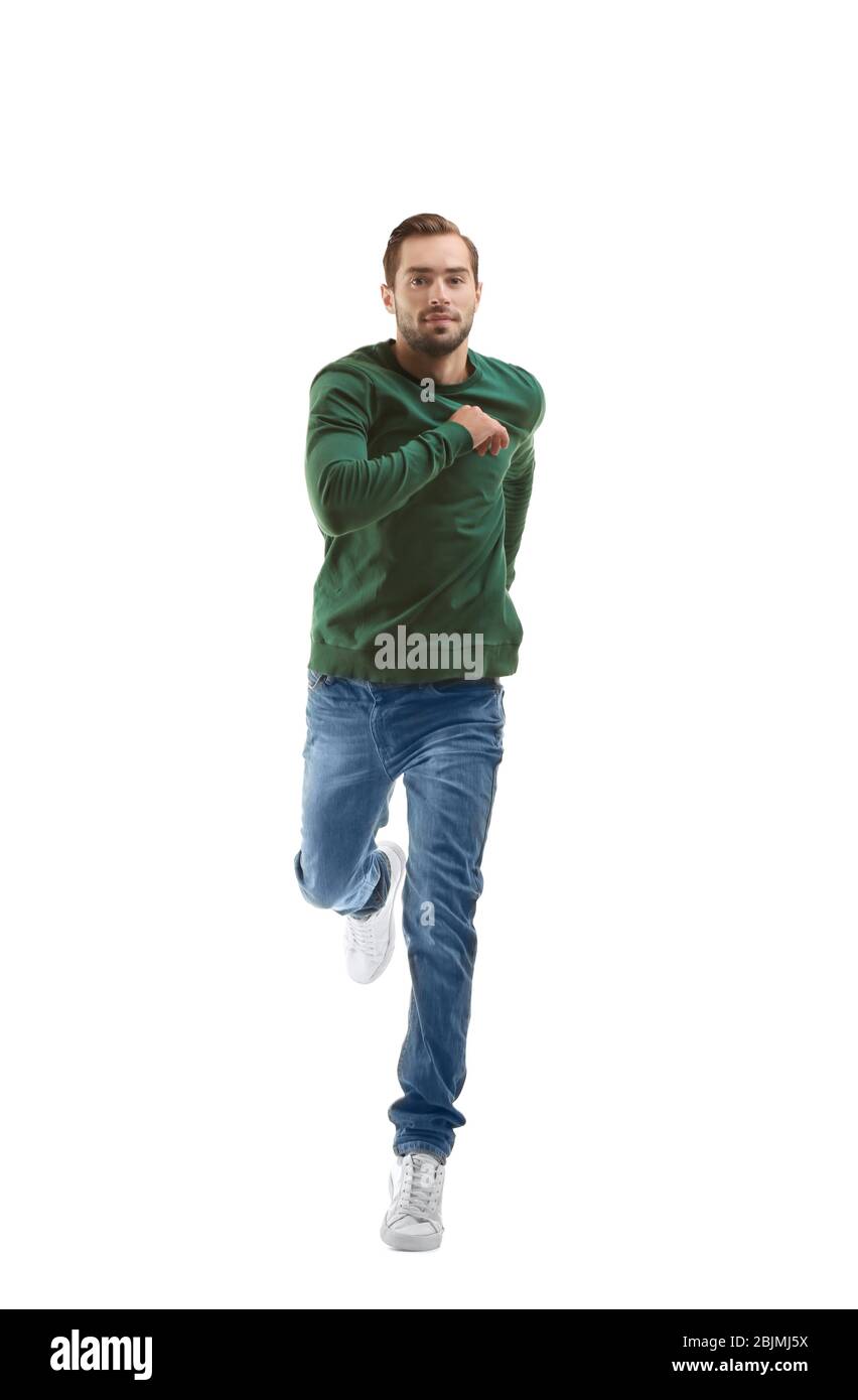 Young man in casual clothes running on white background Stock Photo - Alamy