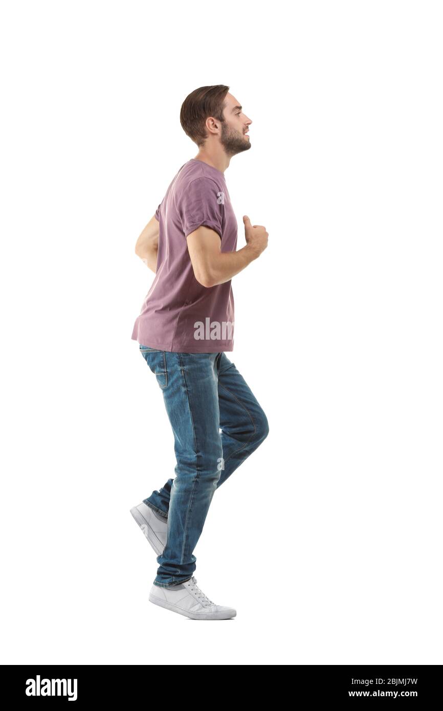 Young man in casual clothes running on white background Stock Photo - Alamy