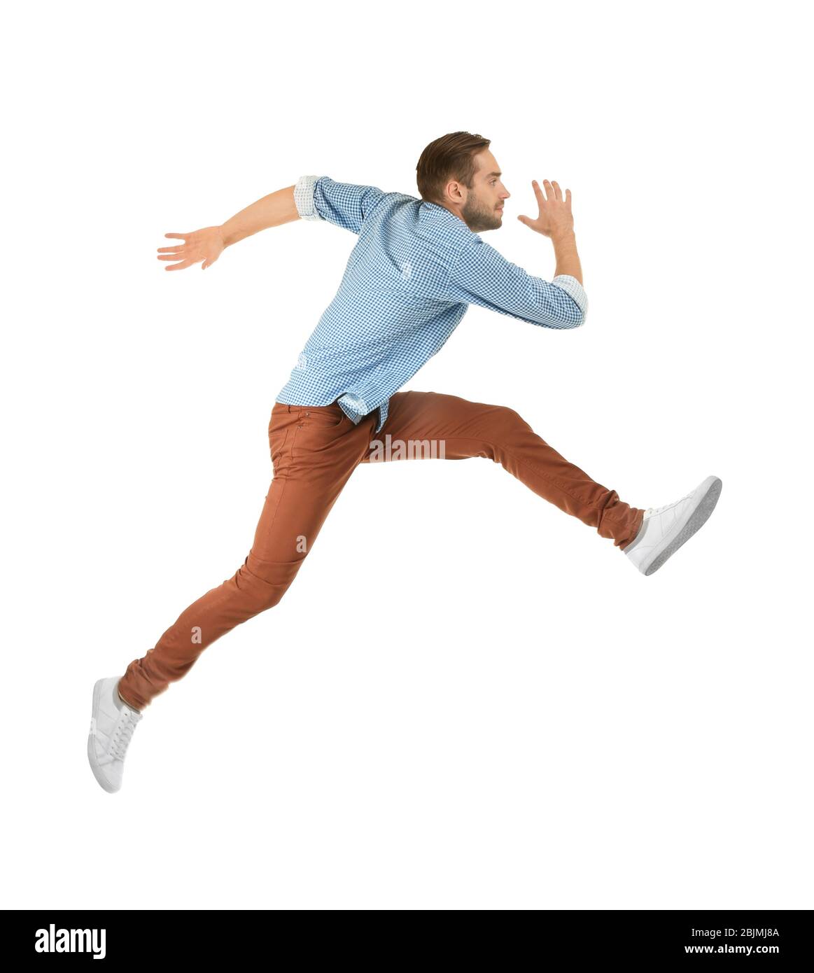 Young man in casual clothes running on white background Stock Photo - Alamy