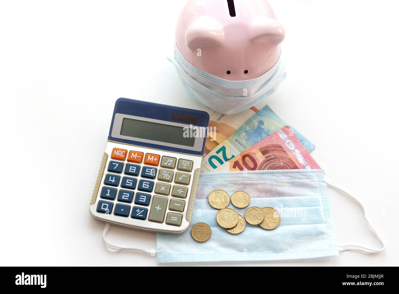 piggy bank wearing protective face mask with euro money on white ...
