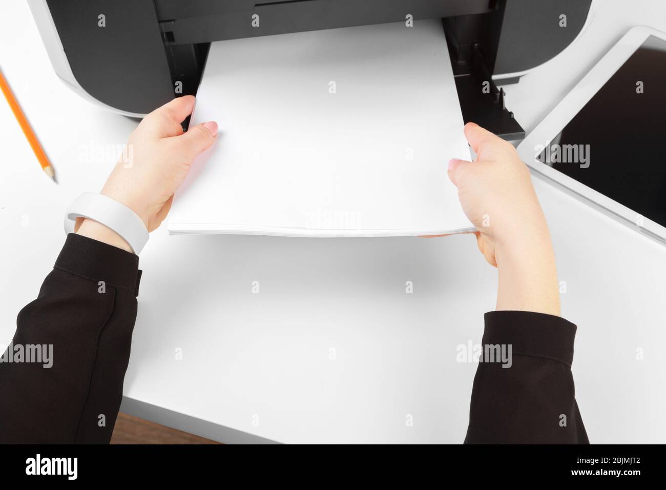 Woman using the printer to scanning and printing document Stock Photo ...