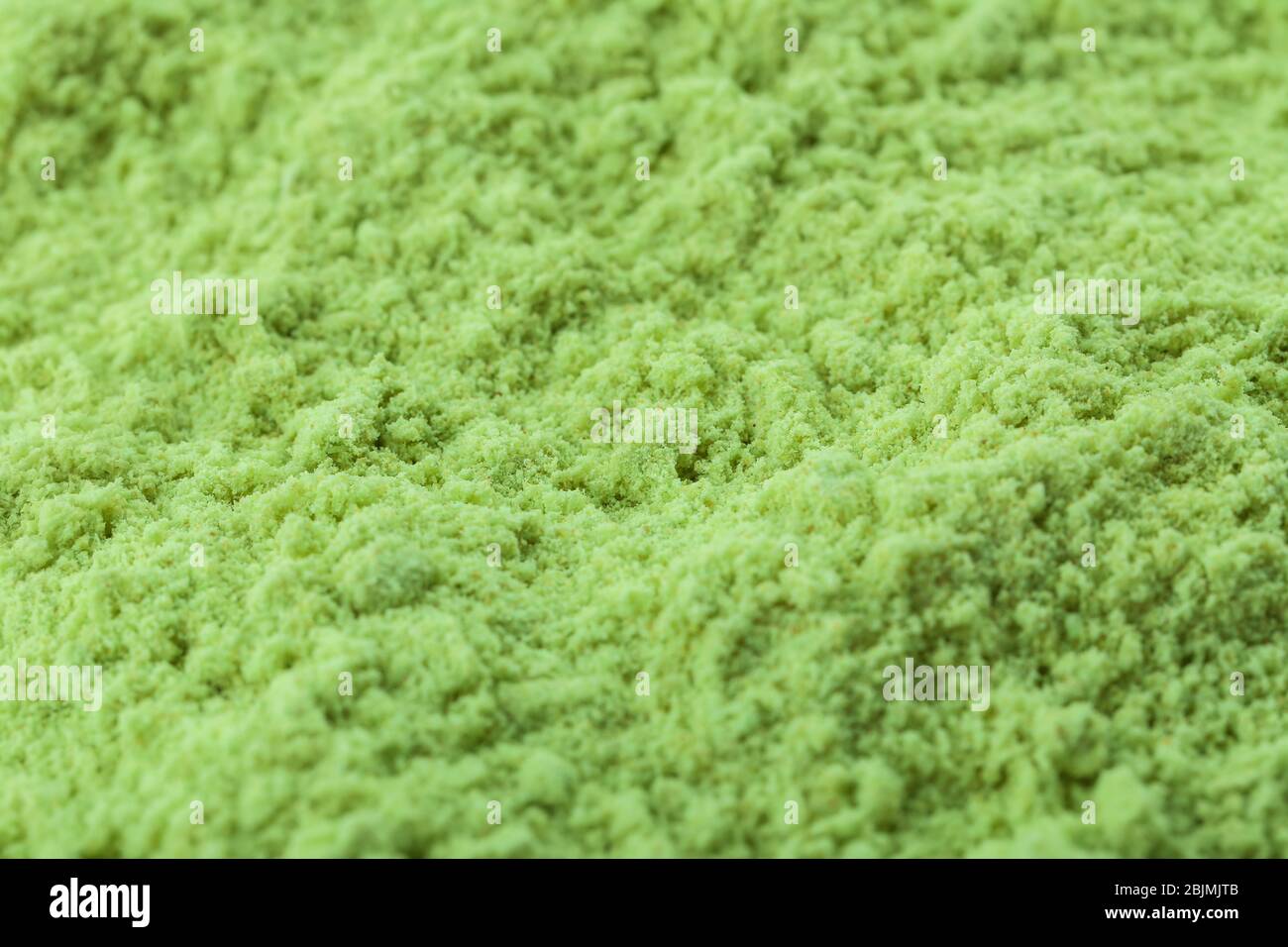 Nutrient-enriched wheat grass powder as background Stock Photo - Alamy