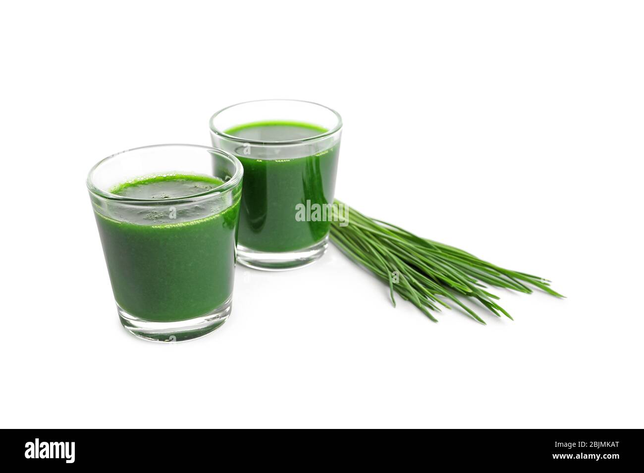 Wheat grass shots on white background Stock Photo - Alamy
