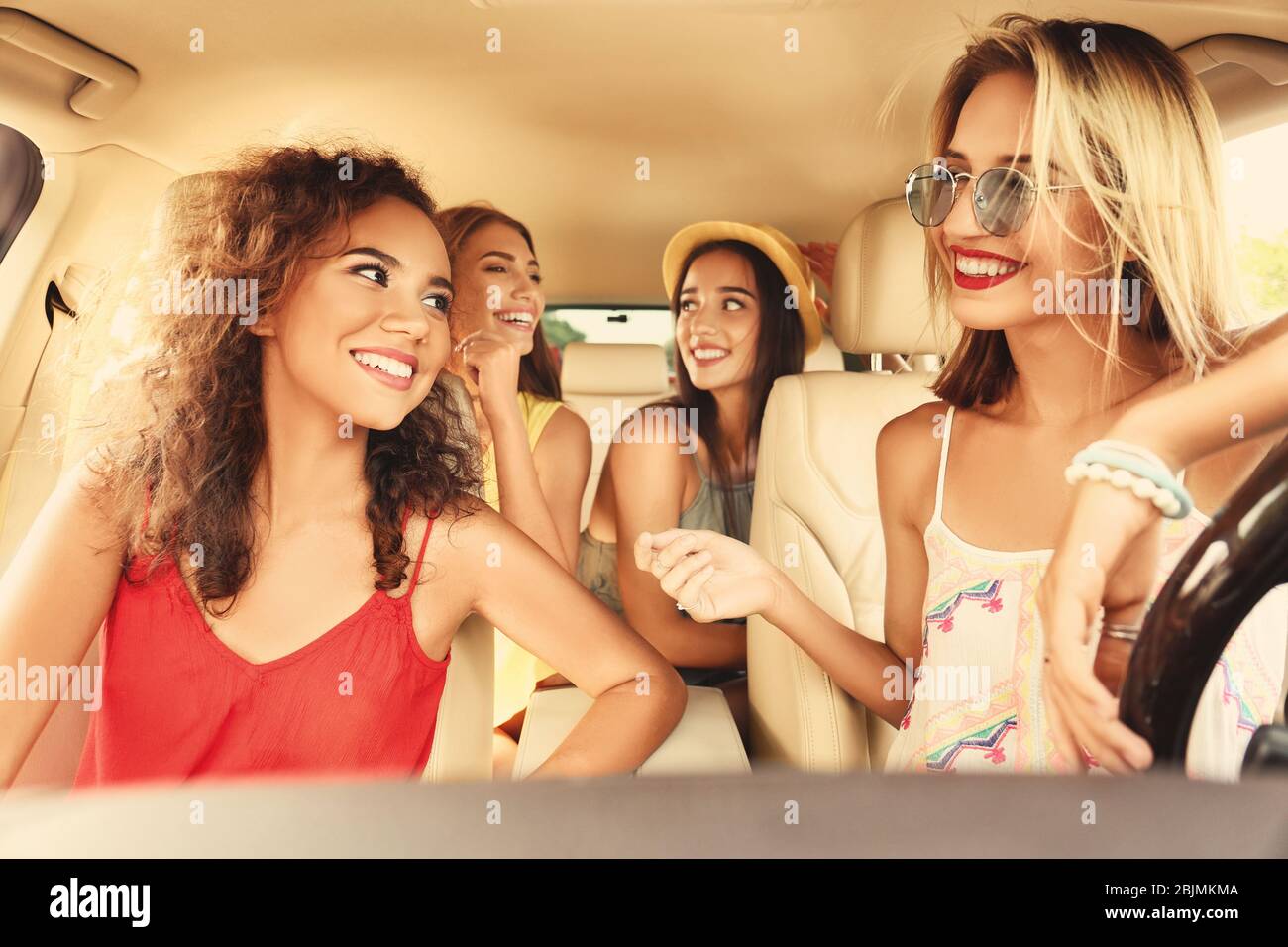 Happy friends having fun together in car Stock Photo - Alamy