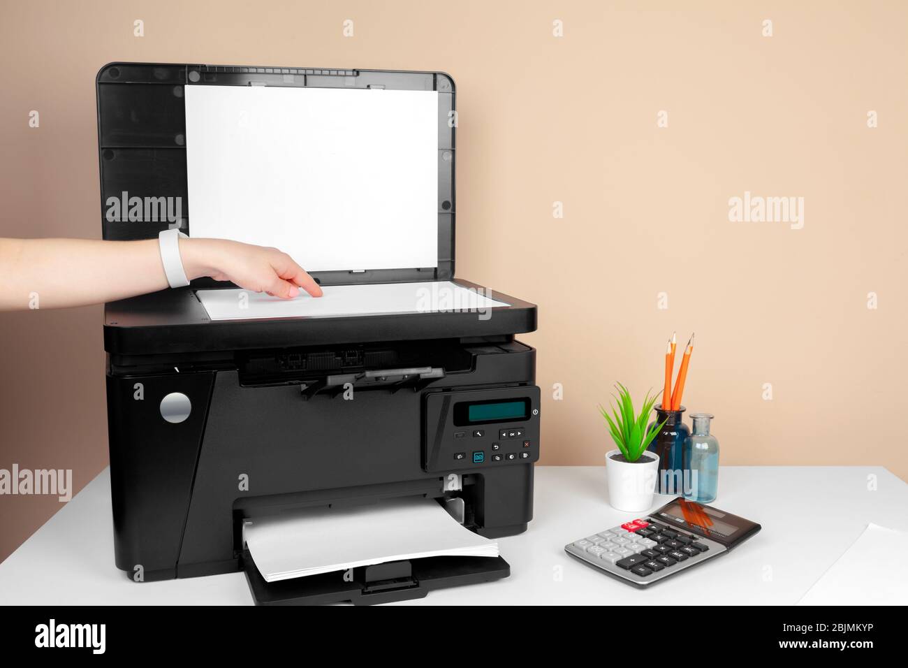 Woman using the printer to scanning and printing document Stock Photo ...
