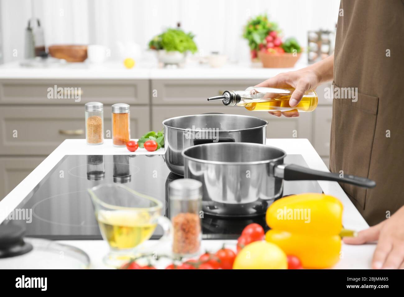 Man pouring cooking oil hi-res stock photography and images - Alamy