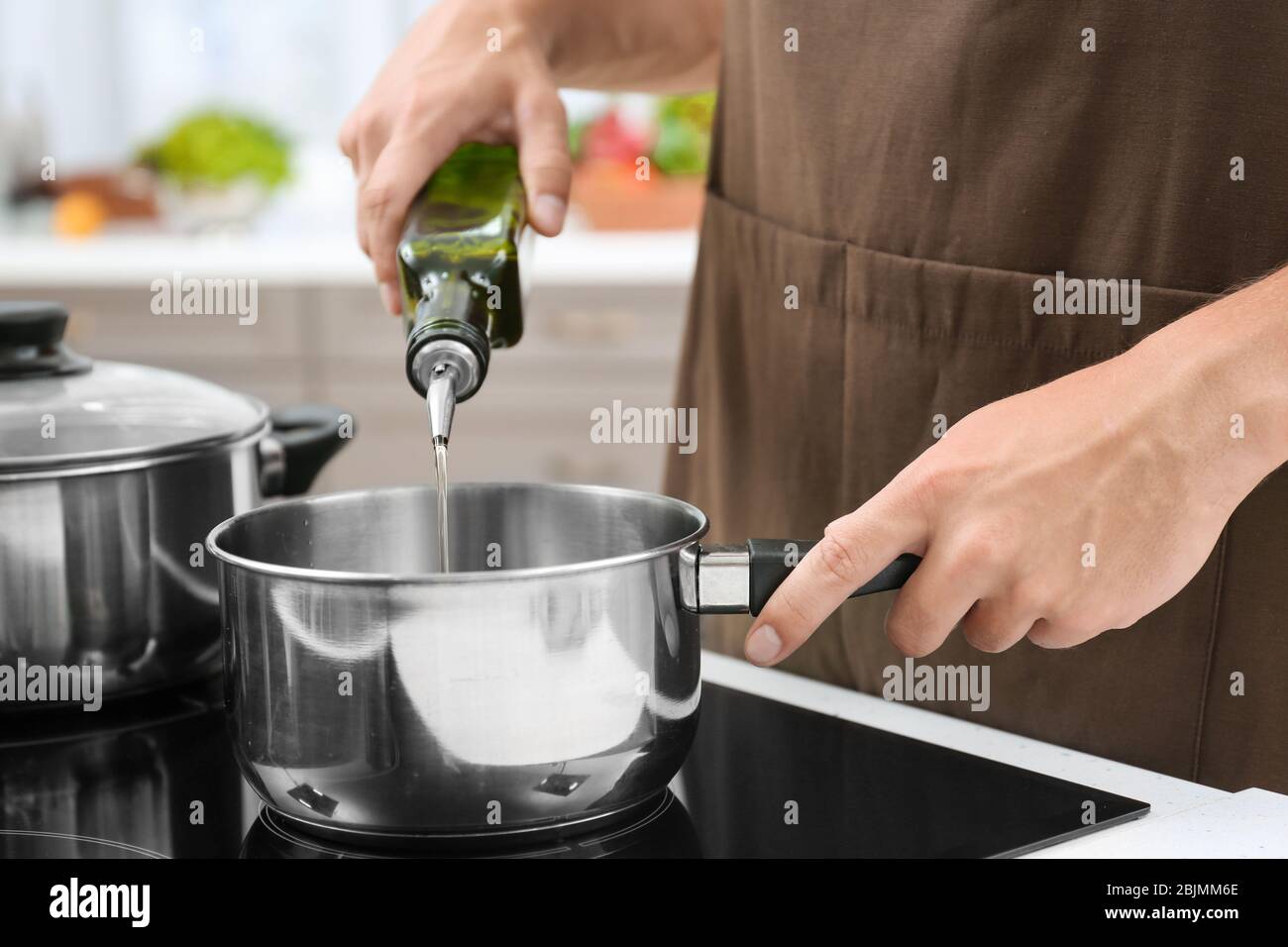 Man pouring cooking oil hi-res stock photography and images - Alamy