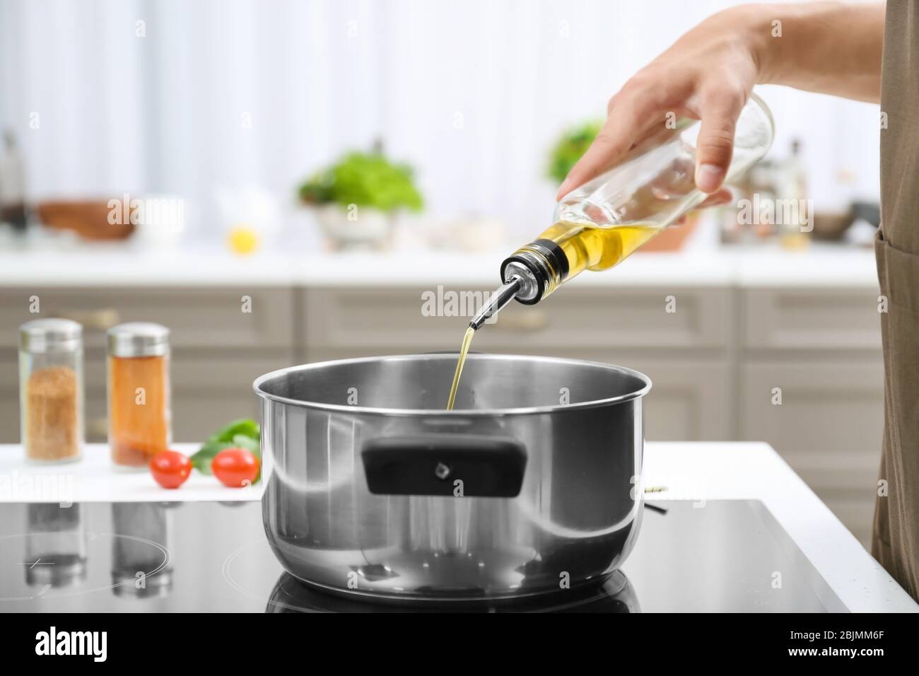 Man pouring cooking oil hi-res stock photography and images - Alamy