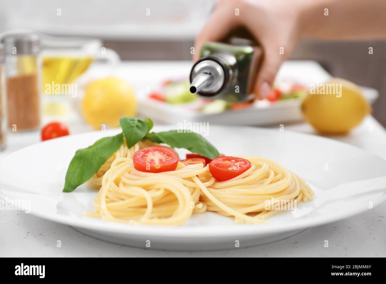 Chef pouring oil on vegetable hi-res stock photography and images - Alamy