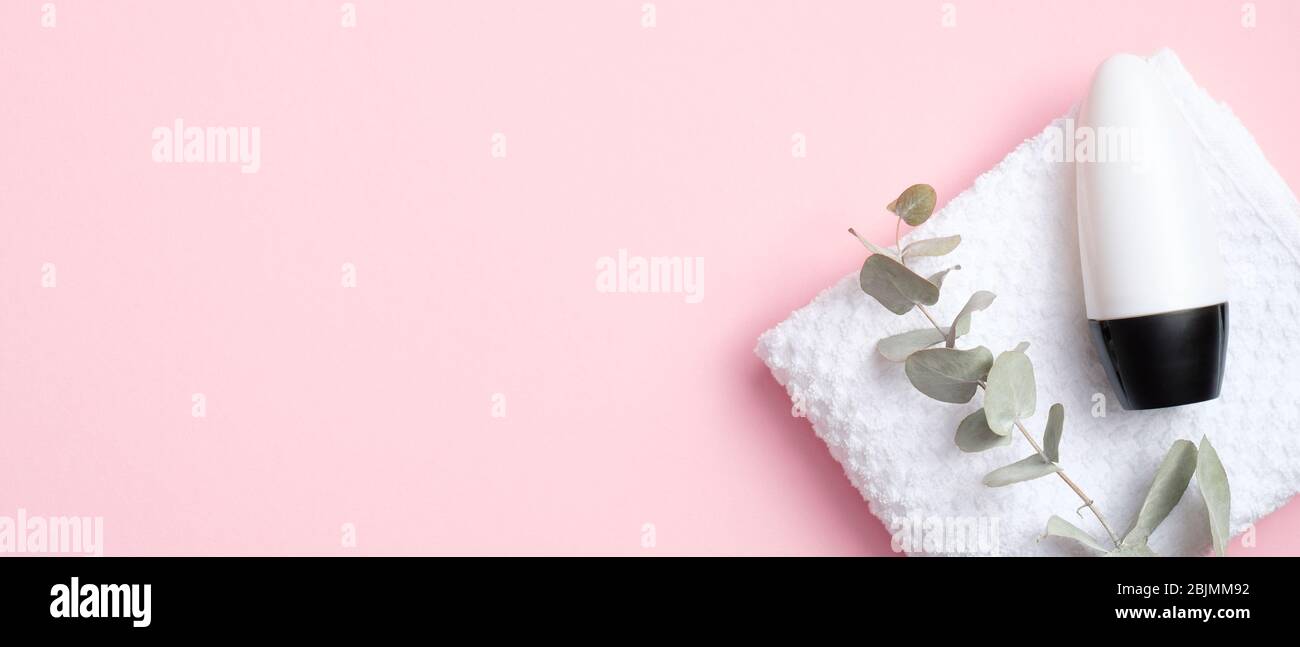 Wide banner template with deodorant bottle, eucalyptus and towel on ...