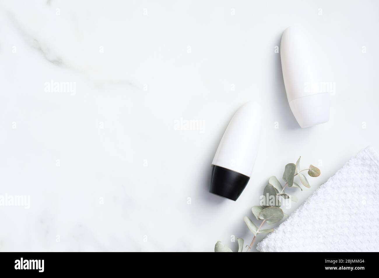 Deodorant bottles mockups with eucalyptus and towel on marble ...