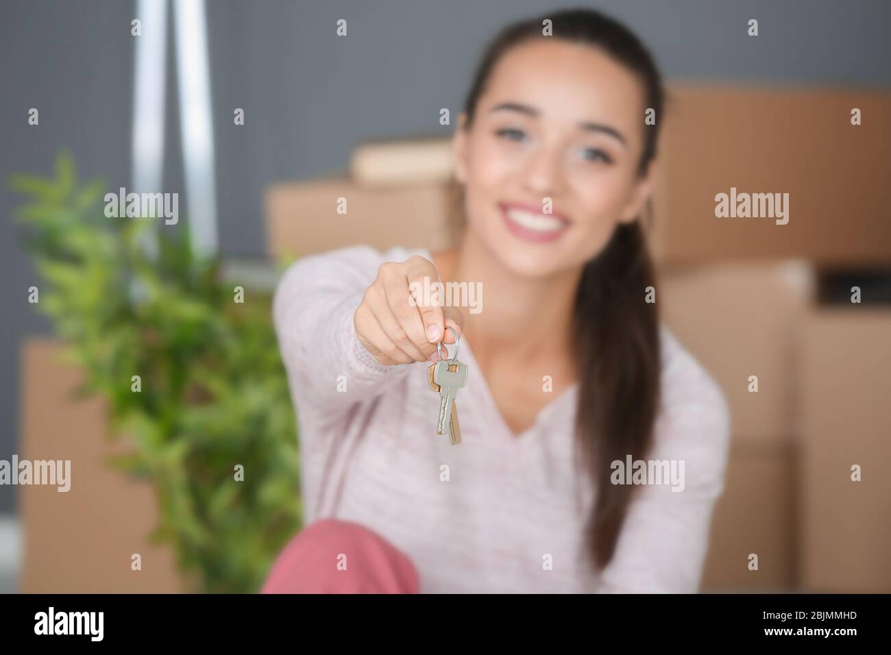 Woman holding keys from new hi-res stock photography and images - Alamy