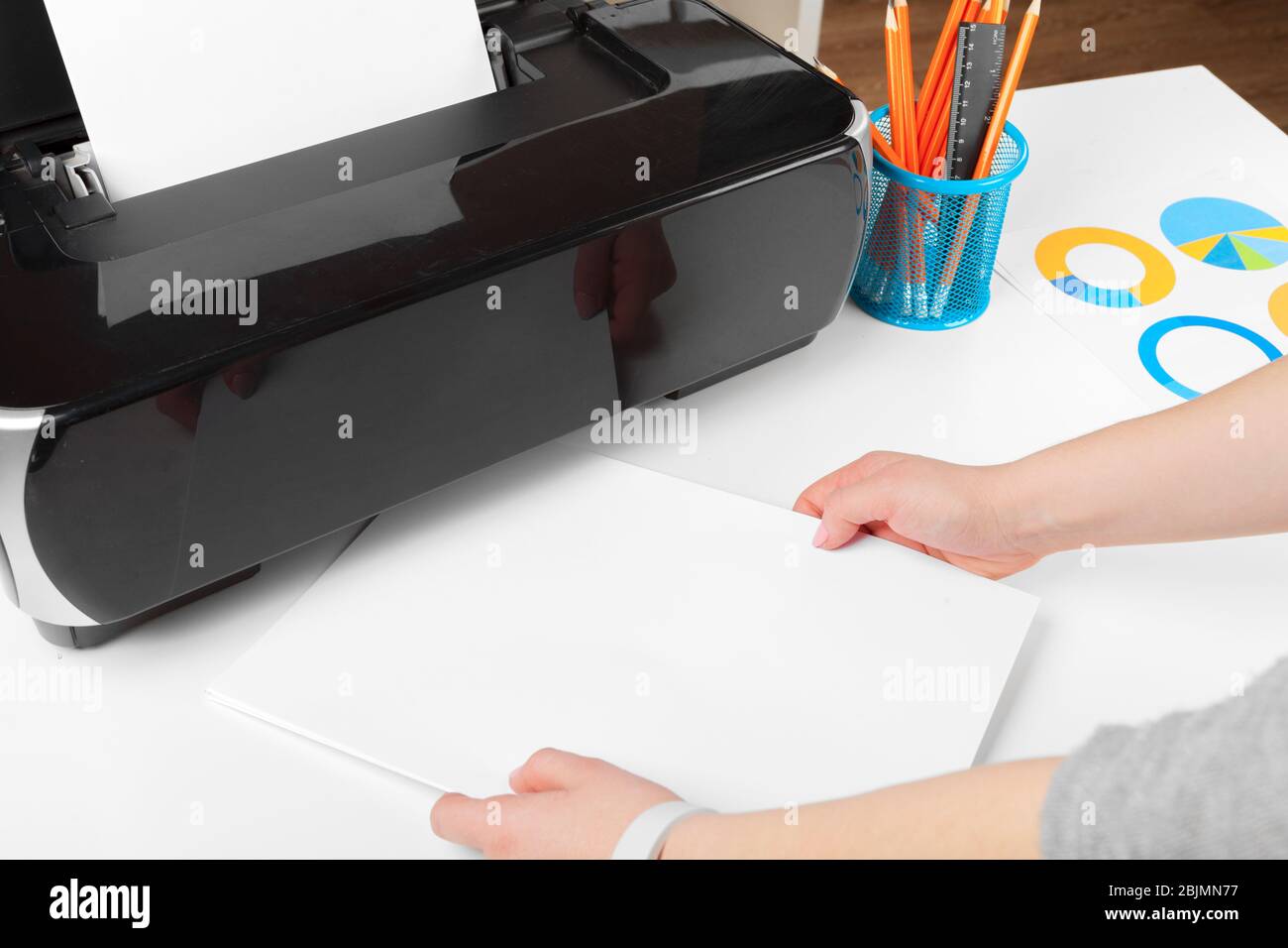 Woman using the printer to scanning and printing document Stock Photo ...