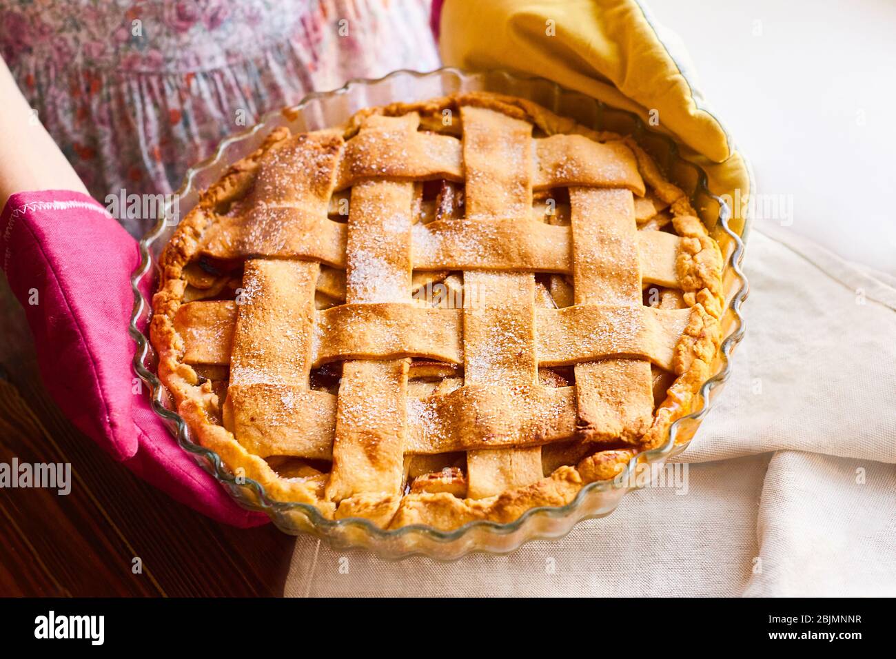Layout or still life with home made apple pie on table covered with ...