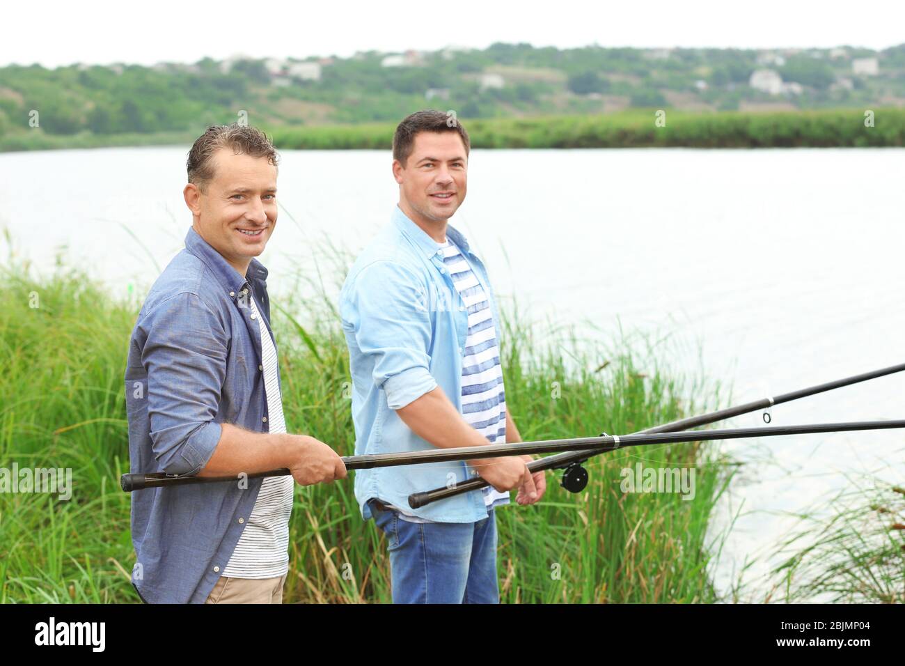 Men fishing on river bank hi-res stock photography and images - Alamy